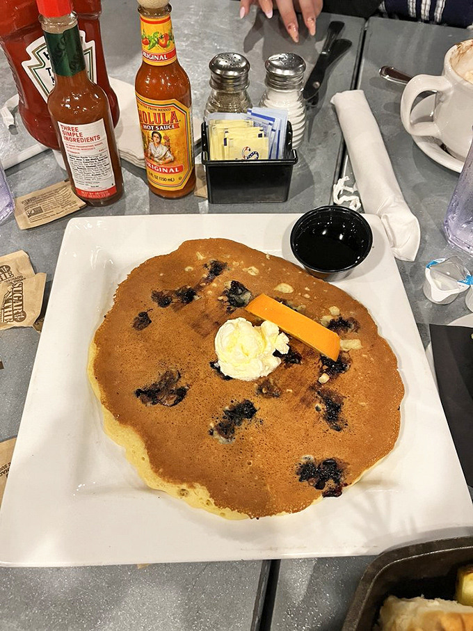 This pancake isn't just big—it's "needs its own zip code" big, with blueberries that pop like flavor fireworks in every bite.
