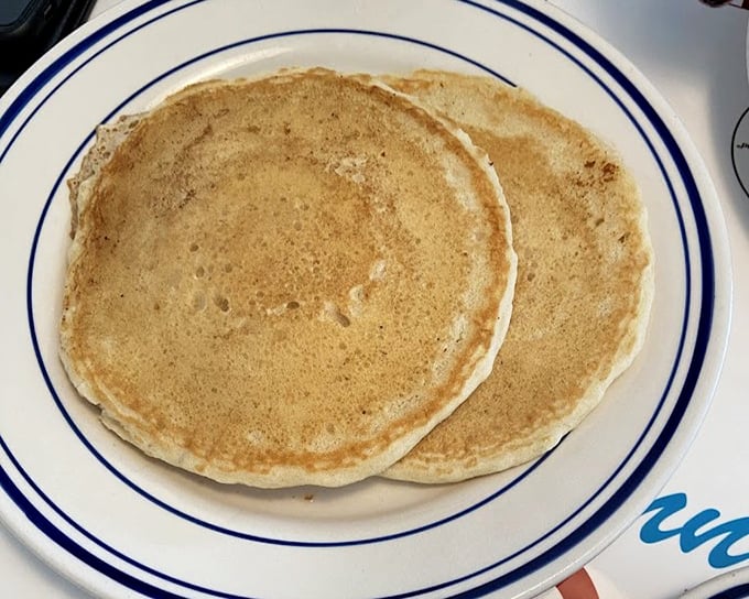 Pancakes that achieve the impossible – golden outside, cloud-like inside. Two perfect circles of breakfast joy that make you question why you ever make them at home.