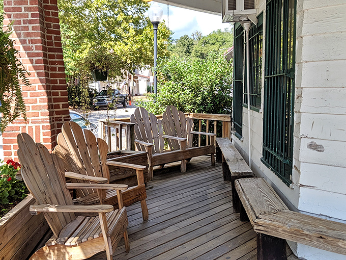 The front porch isn't just an entrance—it's a Southern living room where the rocking chairs practically whisper "sit a spell" as you pass by.