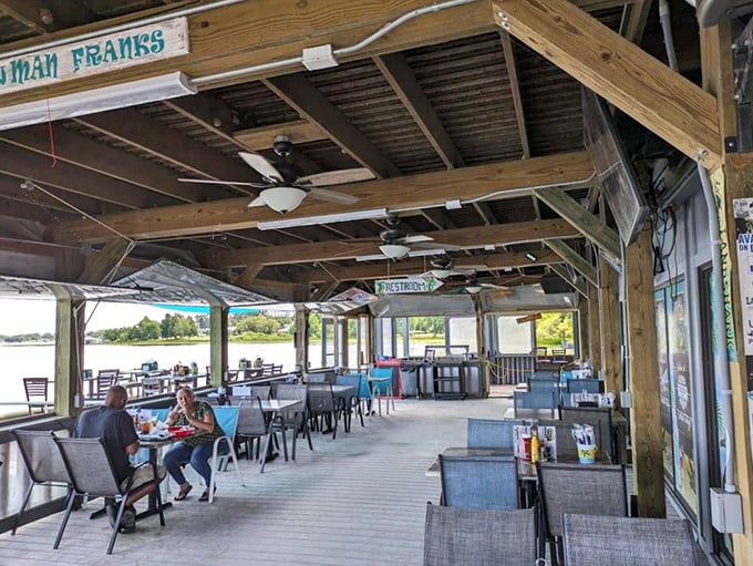 The covered patio offers al fresco dining with water views that turn a simple meal into an occasion worth remembering.