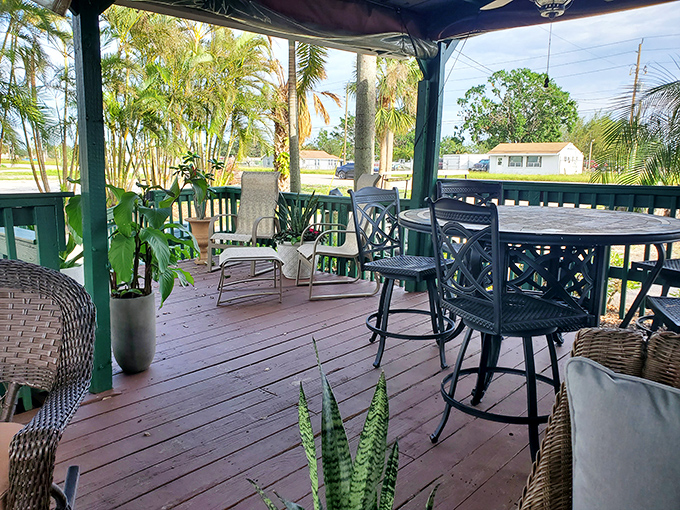 The wraparound porch offers breezy outdoor seating surrounded by lush greenery. Florida dining as it should be—relaxed and natural.