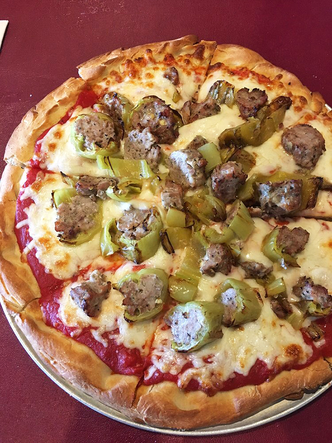 Pizza that proves sausage and green peppers aren't just toppings—they're supporting actors in the delicious drama unfolding on your plate.
