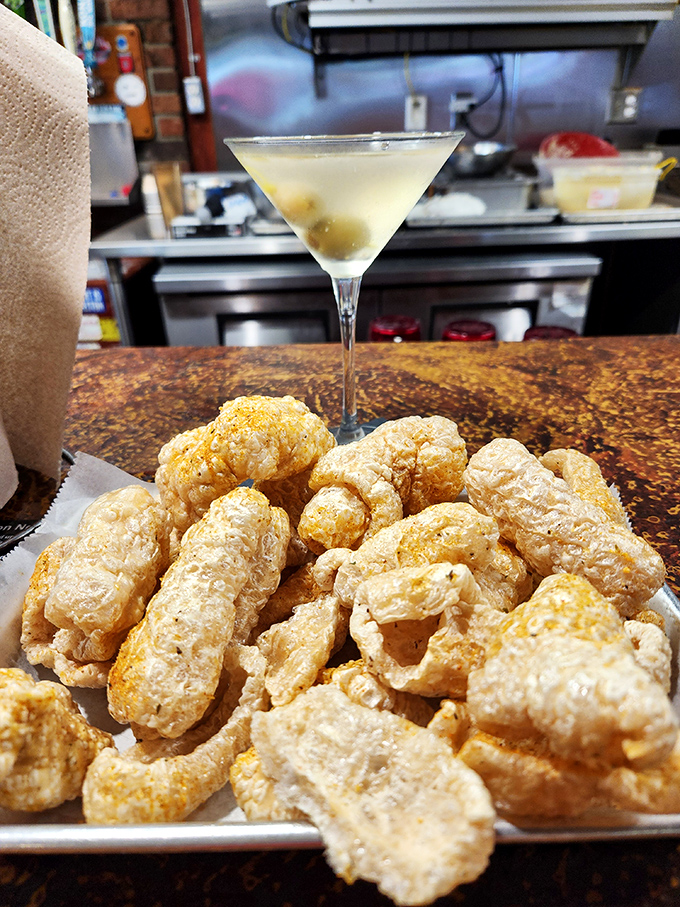 Pork rinds and martinis—the pairing nobody asked for but everyone needs. Southern comfort food meets sophisticated cocktail hour.