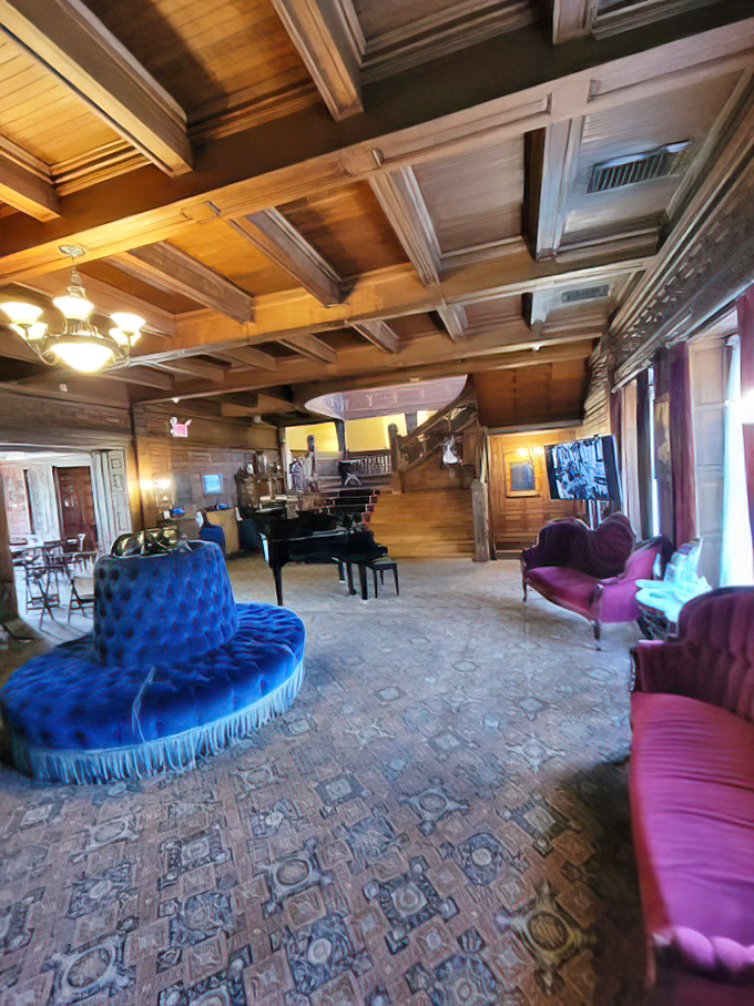 The receiving room's wooden ceiling beams and circular blue settee create a parlor that's equal parts Architectural Digest and time machine.