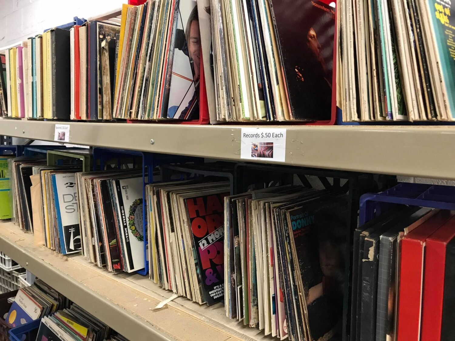 Vinyl victory! These record shelves are like time machines at $0.50 a trip—where musical memories wait to be spun again.