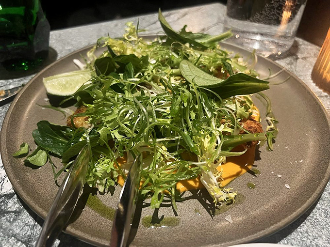 A salad so fresh and vibrant it practically photosynthesizes on the plate. Those greens aren't just healthy—they're an essential counterpoint to seafood indulgence.