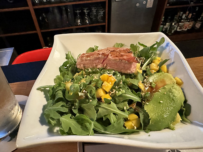 This isn't just a salad—it's a colorful canvas where greens, mango, and perfectly cooked protein come together in a masterpiece of healthy indulgence.