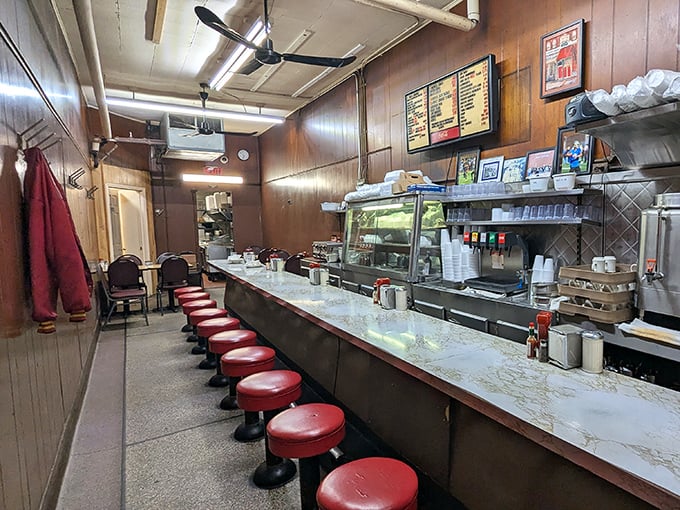 The narrow dining room with its wood-paneled charm feels like eating in your grandmother's kitchen—if grandma could cook for a crowd.