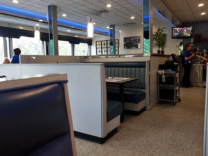Blue vinyl booths standing at attention like soldiers guarding the sacred diner experience – private dining kingdoms where breakfast can be enjoyed at any hour.