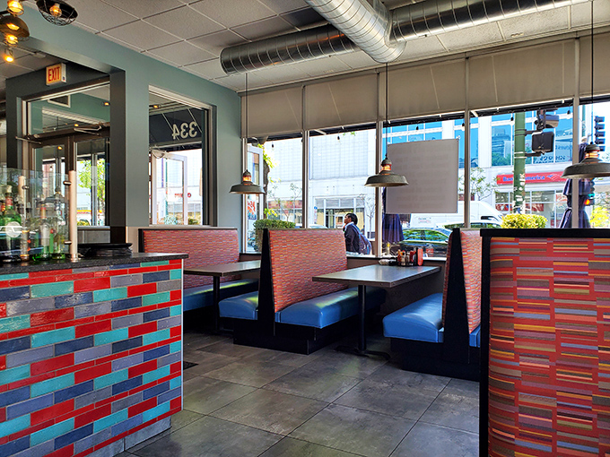 Modern diner aesthetics with colorful tile work and comfortable booths—the perfect setting for contemplating a second helping of French toast.