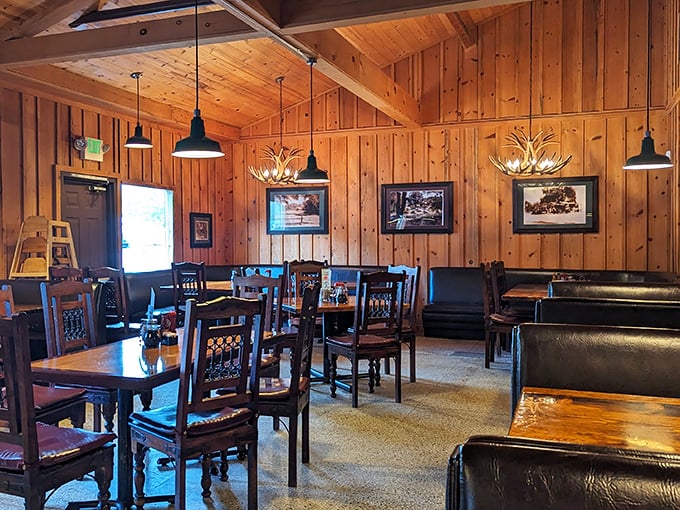Dining room perfection – where antler chandeliers cast a warm glow over wooden tables that have hosted thousands of memorable meals and conversations.