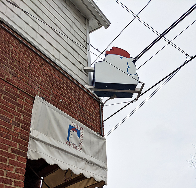 That cheerful chicken mascot has been watching over this corner like a poultry guardian angel for generations.