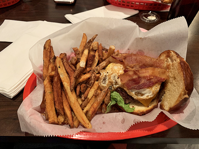 This smash burger with bacon and hand-cut fries isn't just a meal – it's a religious experience on a red basket.