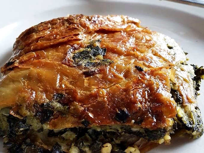 This isn't just spinach pie—it's a golden-crusted treasure chest filled with savory delights that would make Popeye weep with joy.
