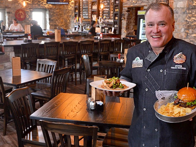 The tavern's chef proudly presents his creations with the confidence of someone who knows he's about to make your day better.