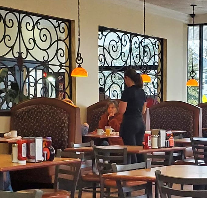 Where magic happens: a server delivers morning sustenance to grateful patrons. The coffee-to-table pipeline remains uninterrupted.