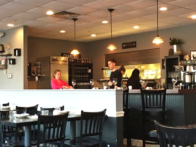 Where the magic happens—the open kitchen design lets you witness culinary choreography while building delicious anticipation for what's heading to your table.