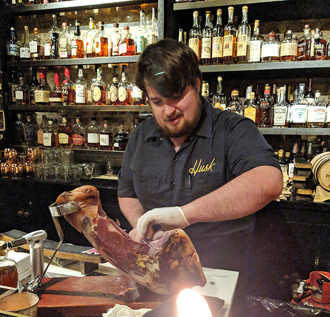 Craftsmanship in action—watching Husk's staff hand-slice country ham is like seeing Michelangelo chip away at marble, only with more delicious results.