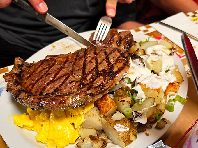 That steak isn't just cooked—it's been treated with the respect a good piece of beef deserves, sharing the spotlight with eggs and potatoes.
