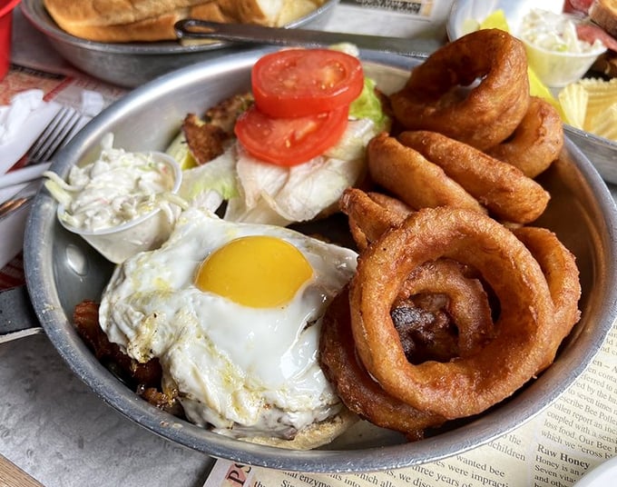 A sunrise burger topped with a perfectly fried egg and onion rings that deserve their own fan club. Breakfast and lunch having a delicious reunion.