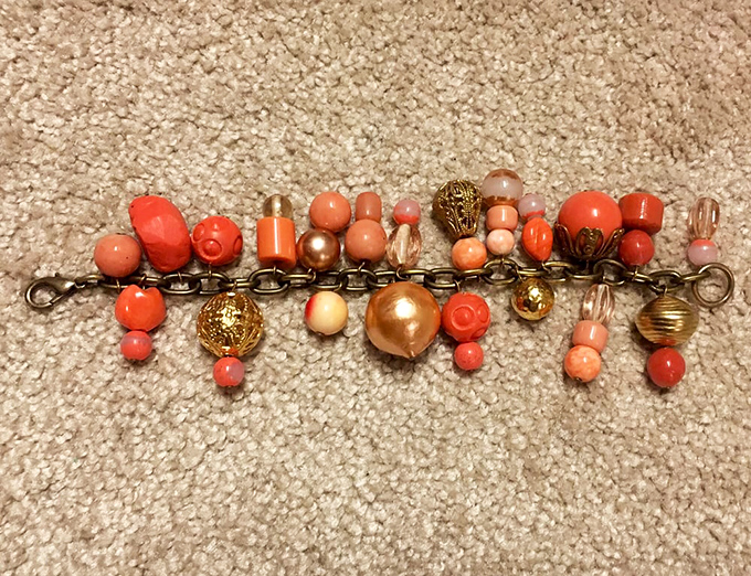 A vintage bracelet that carries decades of stories in its coral beads. Someone once loved this—and someone new will again.