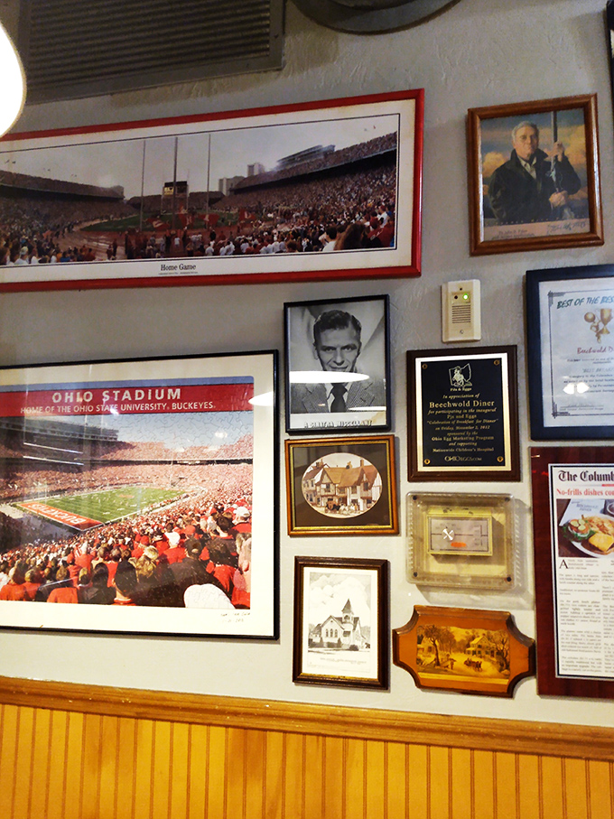 Wall décor that tells you everything: this place loves Columbus, respects tradition, and has earned every framed accolade.