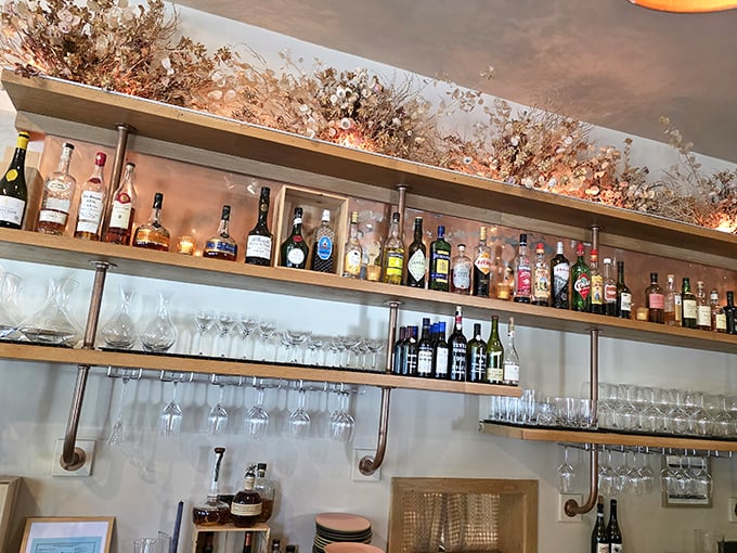 The bar shelves tell stories of carefully selected spirits. That dried floral arrangement above isn't just decoration—it's a hint at the seasonal philosophy below.