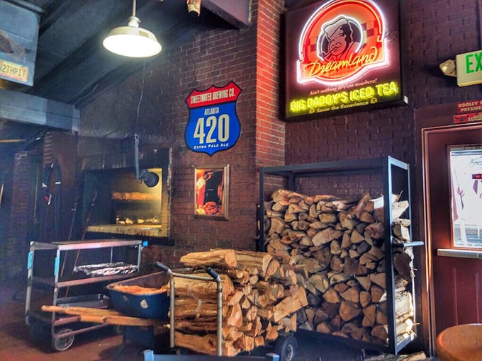 Stacked firewood reveals the secret behind Dreamland's authentic flavor. This isn't gas-powered convenience—it's the old-school commitment to doing things right.