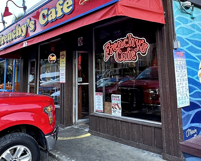 Red awning, blue fish mural—visual appetizers before the main event of perfectly prepared grouper.