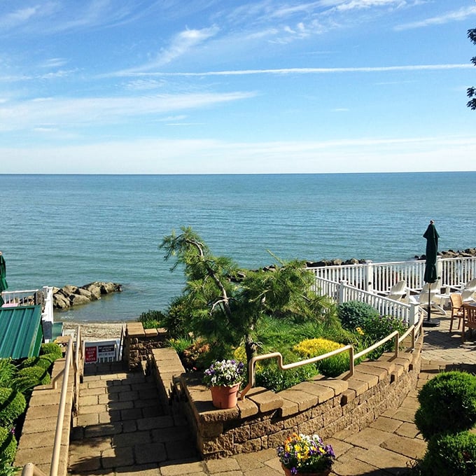 Steps lead down to Lake Erie's shores at Geneva-on-the-Lake, where the water stretches to the horizon like nature's infinity pool.