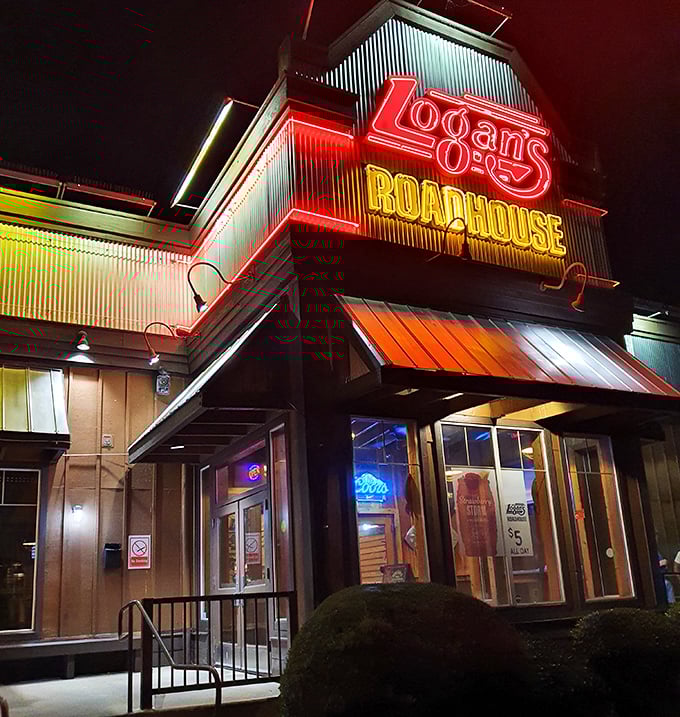 Logan's neon-lit exterior glows with roadhouse promise - where hand-cut steaks and down-home atmosphere create unforgettable dining memories.