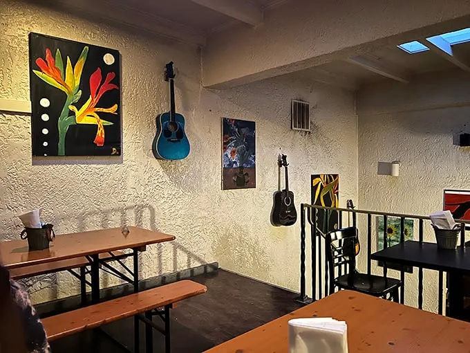 The upstairs dining area feels like your coolest friend's apartment—complete with guitars on the wall and art that doesn't take itself too seriously.