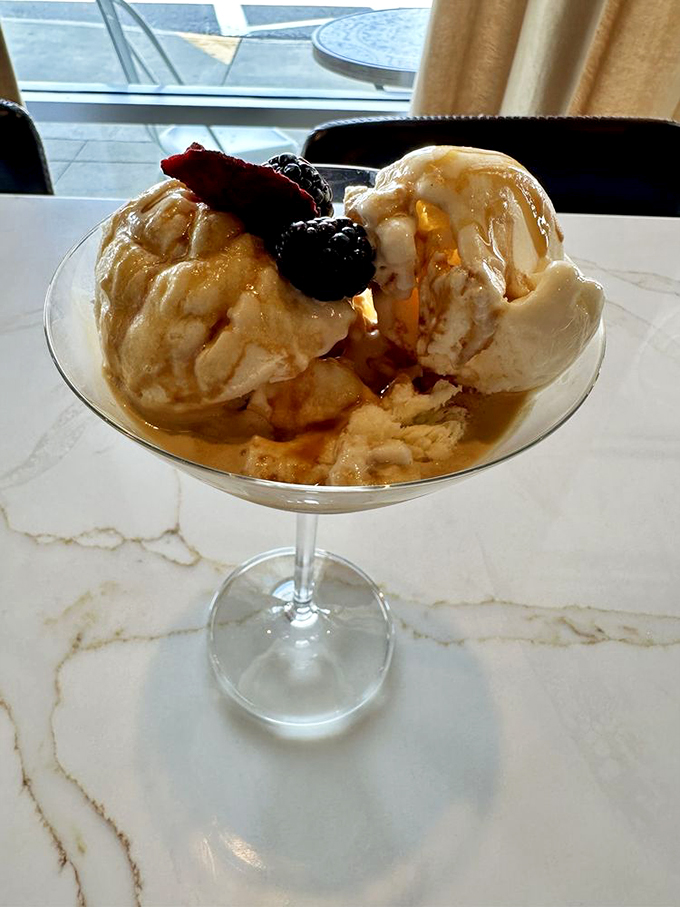 Ice cream melting into espresso with fresh berries—the affogato here isn't just dessert, it's a religious experience in a martini glass.