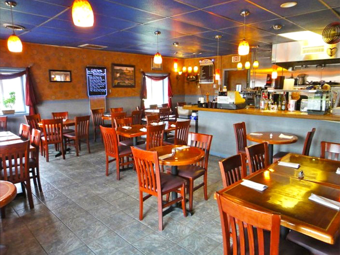 The dining room waits patiently for the dinner rush—each chair ready to support the weight of your impending food happiness.