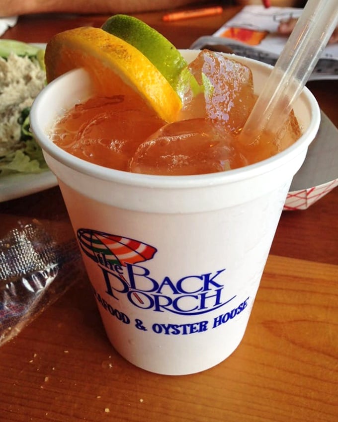The Back Porch Punch – a sunset-colored cocktail that tastes like summer vacation in liquid form. One sip and you're officially on Florida time.
