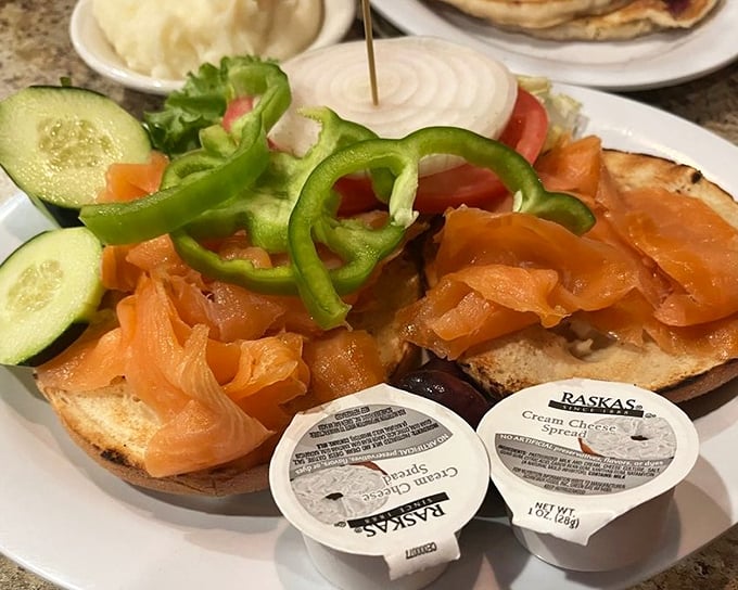The Nova Scotia lox bagel – where silky salmon meets fresh vegetables in a breakfast that feels sophisticated enough to justify reading The New Yorker while eating it.