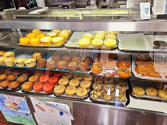The pastry case at Nat's – a glass-enclosed museum of muffins, cinnamon rolls, and other baked treasures that make waiting for a table almost bearable.