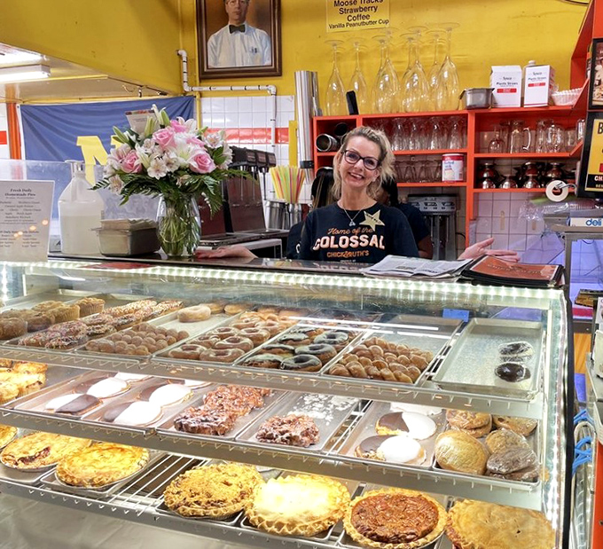 The bakery case—a glass-enclosed museum of temptation where willpower goes to die and happiness begins.