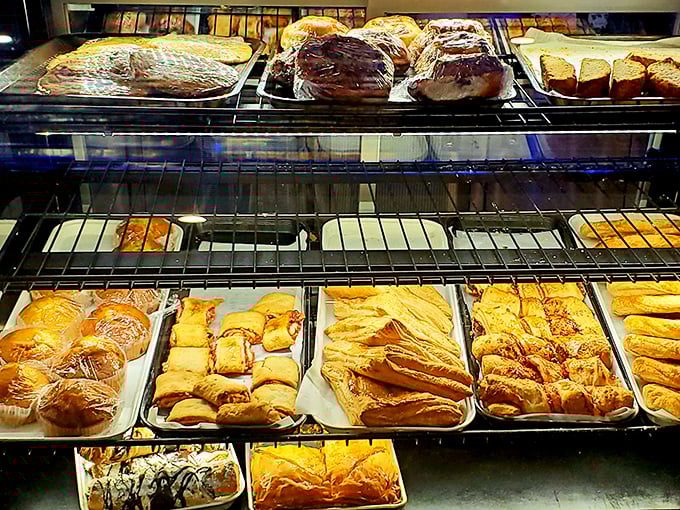 The pastry case of dreams—where willpower goes to die a happy death. Each shelf offers a different path to delicious regret.