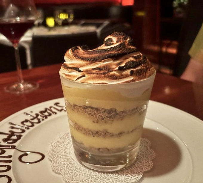 Banana pudding layered like edible architecture, complete with torched meringue that screams "celebration time."