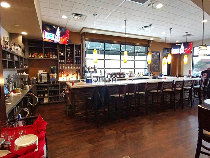 The bar area—where strangers become friends over shared plates and the bartender remembers your usual after just two visits.