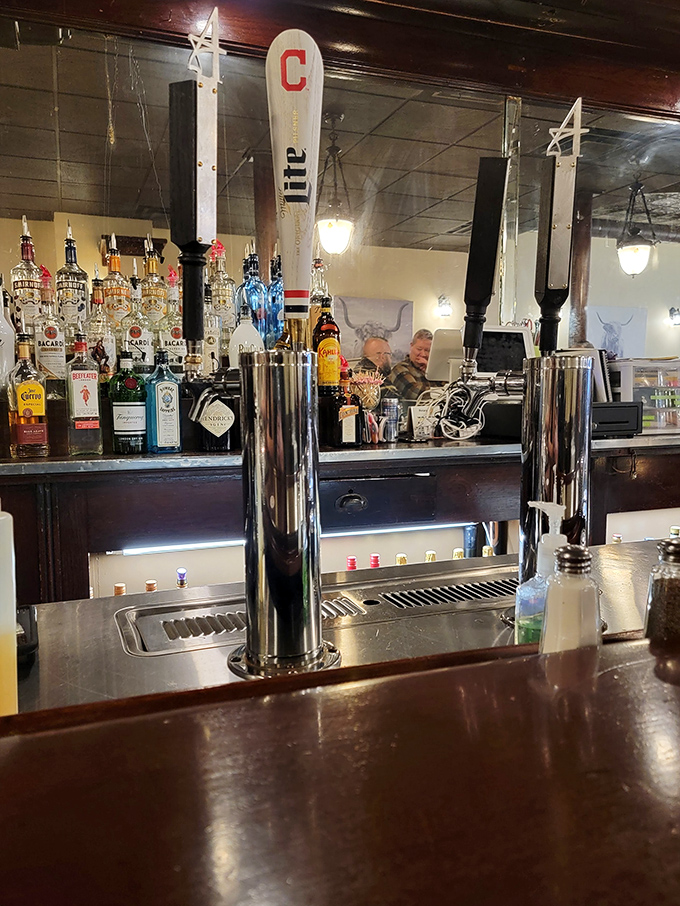 A bar setup that means business, complete with Cleveland pride on tap. Those beer handles aren't just dispensing drinks—they're pouring liquid happiness.