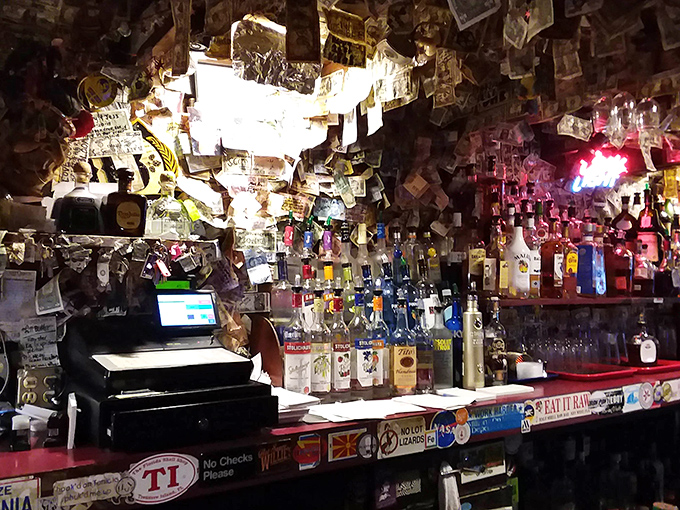 Money on the ceiling, memories on the walls—this bar area has absorbed decades of laughter, stories, and the occasional spilled beer.