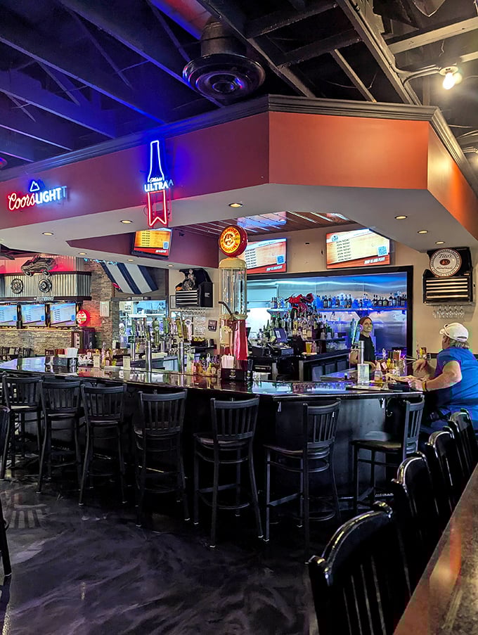The bar glows with neon promise as patrons settle in. This is where Panama City Beach locals come when the tourists are at the chain restaurants.