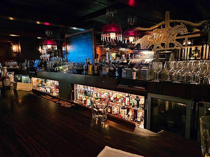 Red lampshades cast a warm glow over one of LA's most impressive liquor collections – liquid history waiting to be poured.