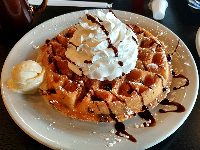 This Belgian waffle topped with whipped cream and chocolate drizzle isn't just breakfast—it's what birthday cake wishes it could be.