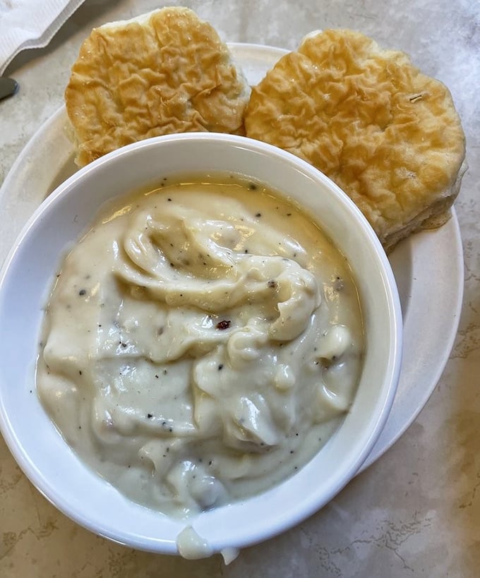 Biscuits standing at attention, ready for their baptism in creamy pepper-flecked gravy—a Southern tradition honored in California style.