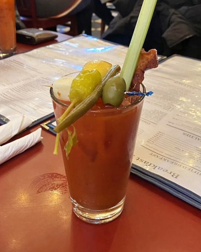 This Bloody Mary isn't just a drink—it's a garden party in a glass, where celery, olives, and bacon have gathered to cure what ails you.