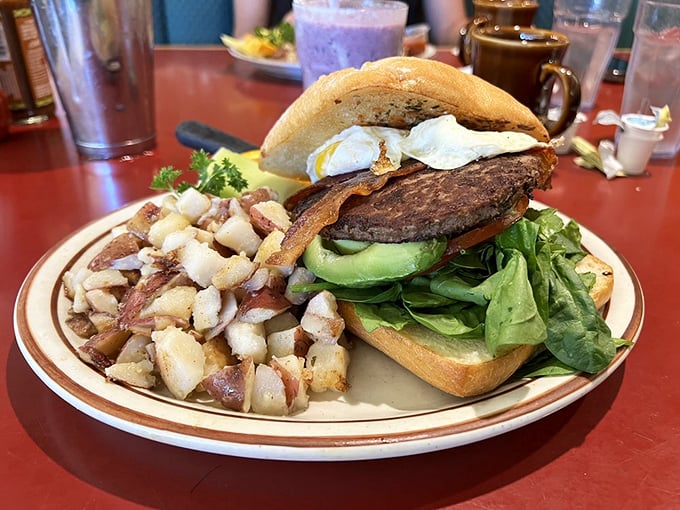 This isn't just a burger—it's a tower of morning glory with avocado, egg, and those hashbrowns that deserve their own zip code.
