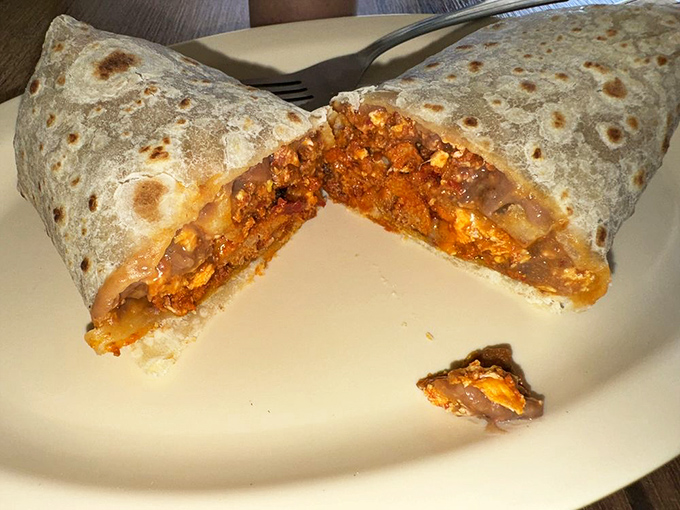 Cut into this breakfast burrito and witness the sunrise of flavors that makes morning people out of night owls.